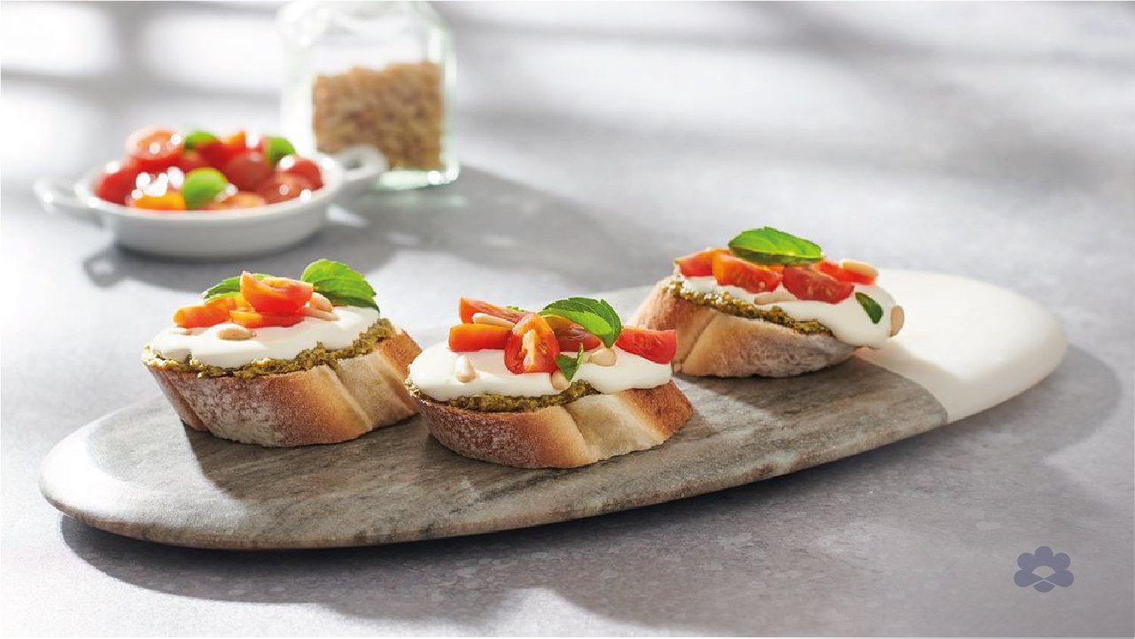 European bread with pesto, cream cheese, cherry tomatoes and pinenuts